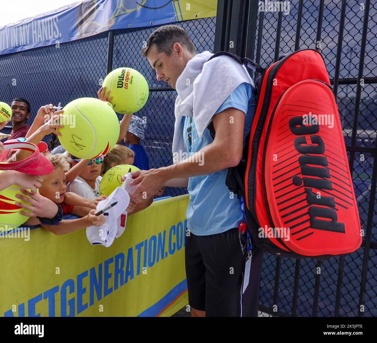 Professional tennis player John Isner of the United States signs ...
