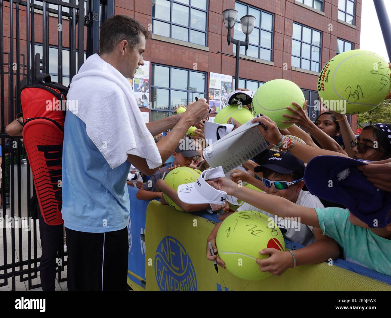 Professional tennis player John Isner of the United States signs ...