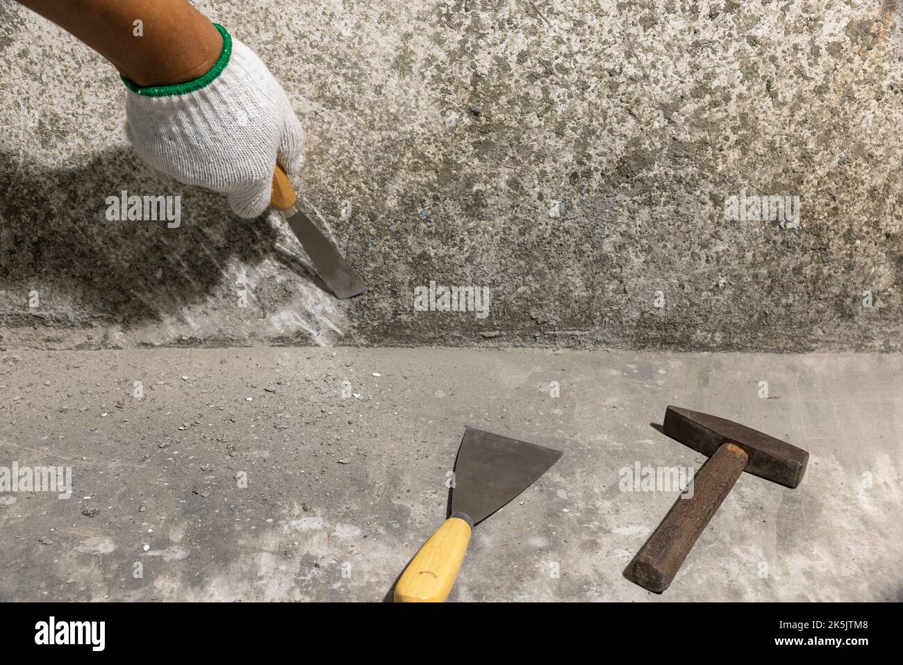 Renovation home , Painter scraping concrete debris on wall from ...