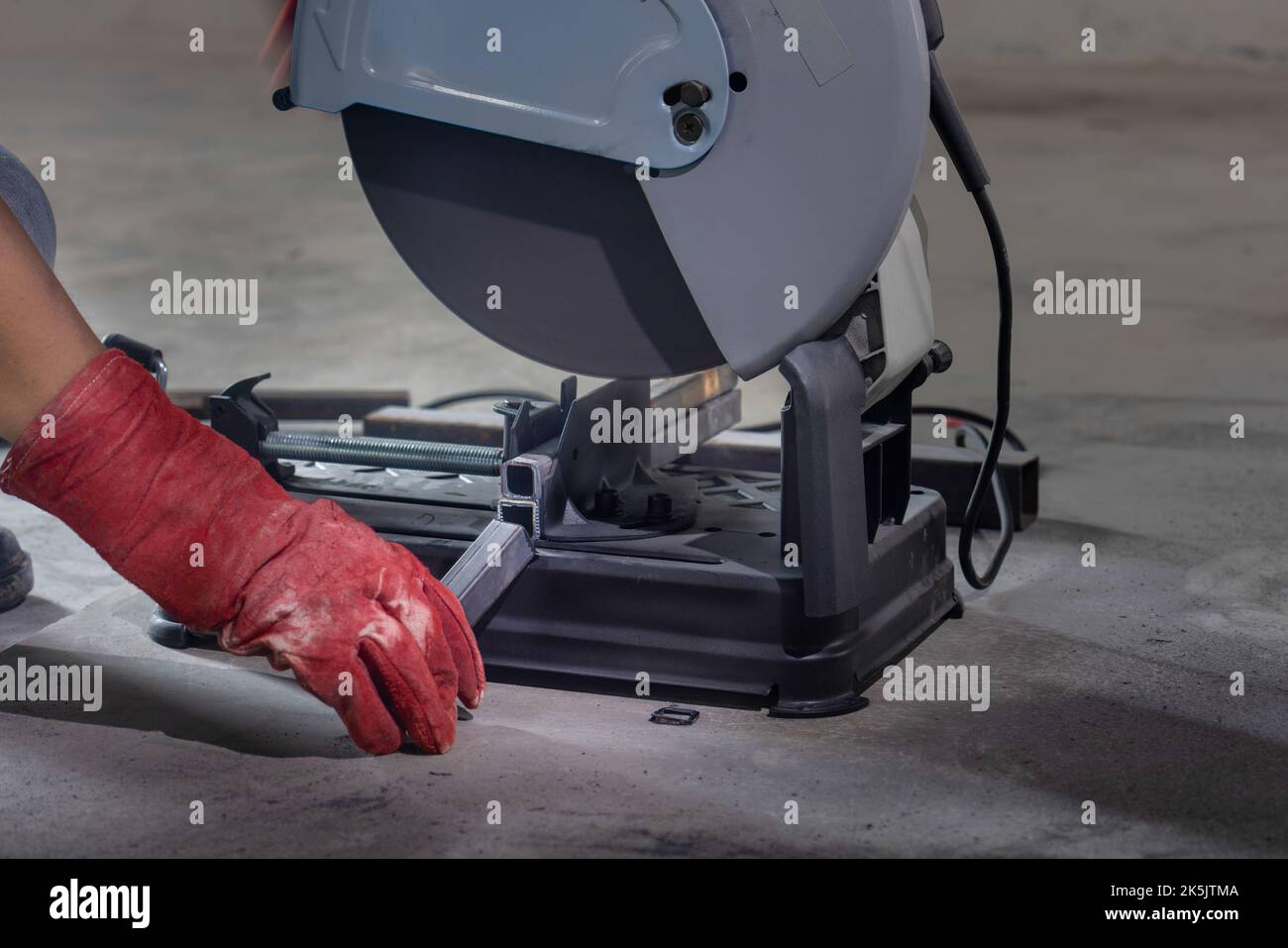 Worker cutting steel rectangular pipe in construction site Stock Photo ...