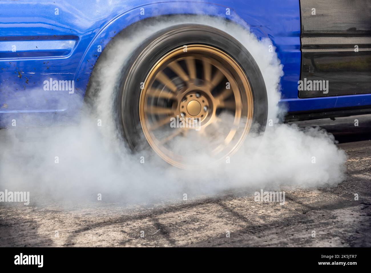Drag racing car burning tire at starting line in race track Stock Photo ...