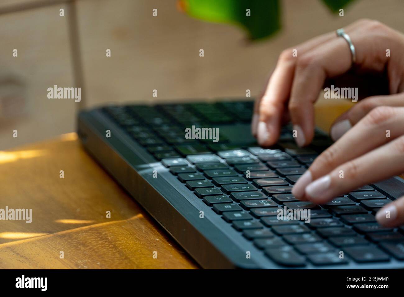 young mexican latina woman, typing on a wireless keyboard on her ...