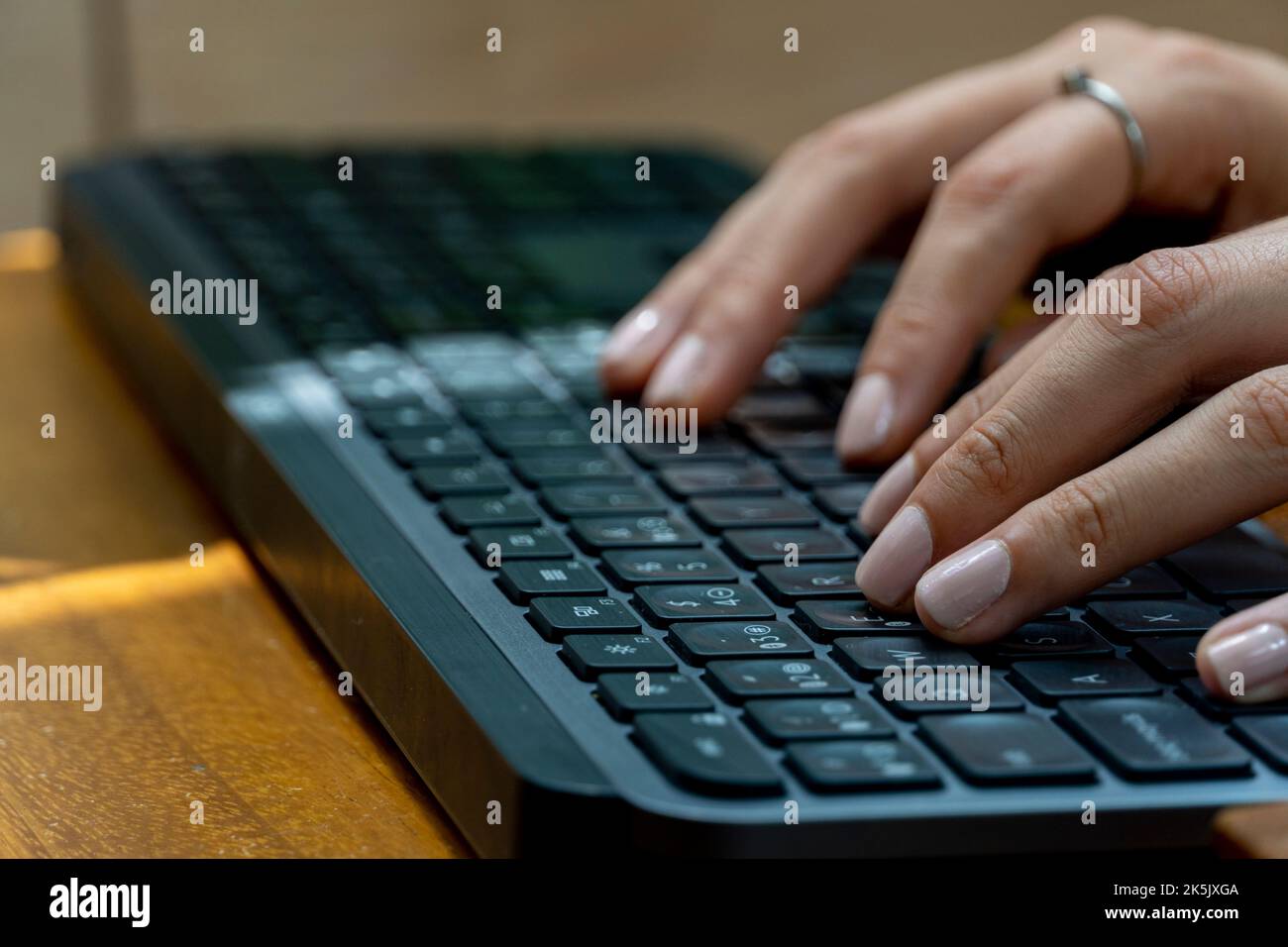 young mexican latina woman, typing on a wireless keyboard on her ...