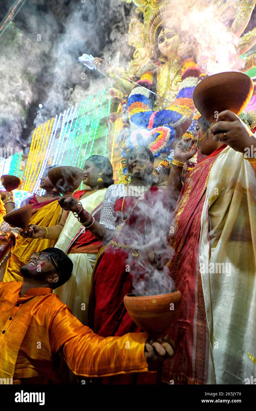 Hindu devotees perform rituals during the immersion procession of Durga ...