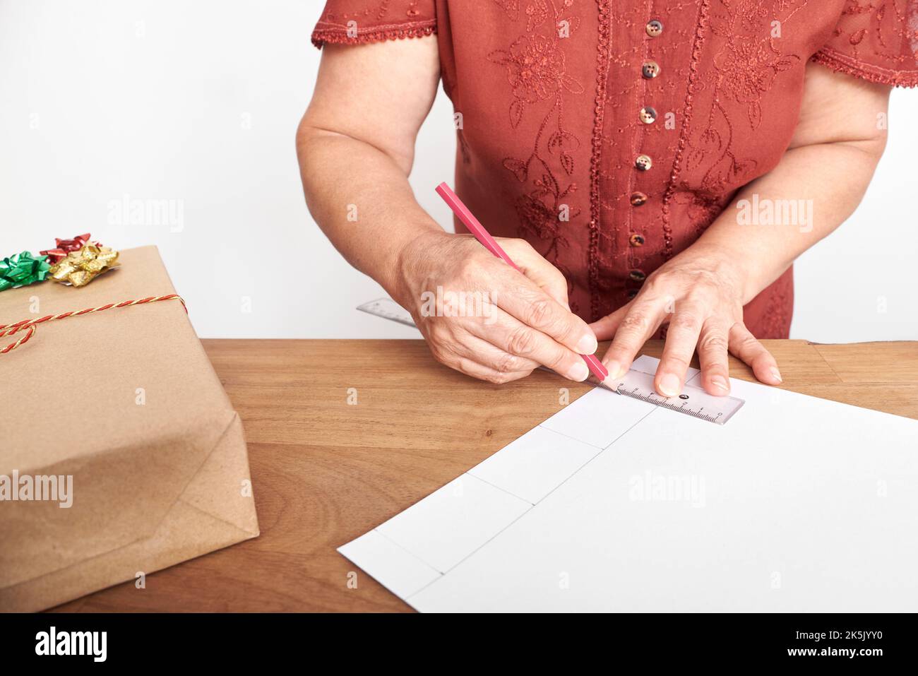 Unrecognizable mature woman measuring with a ruler, making handmade ...