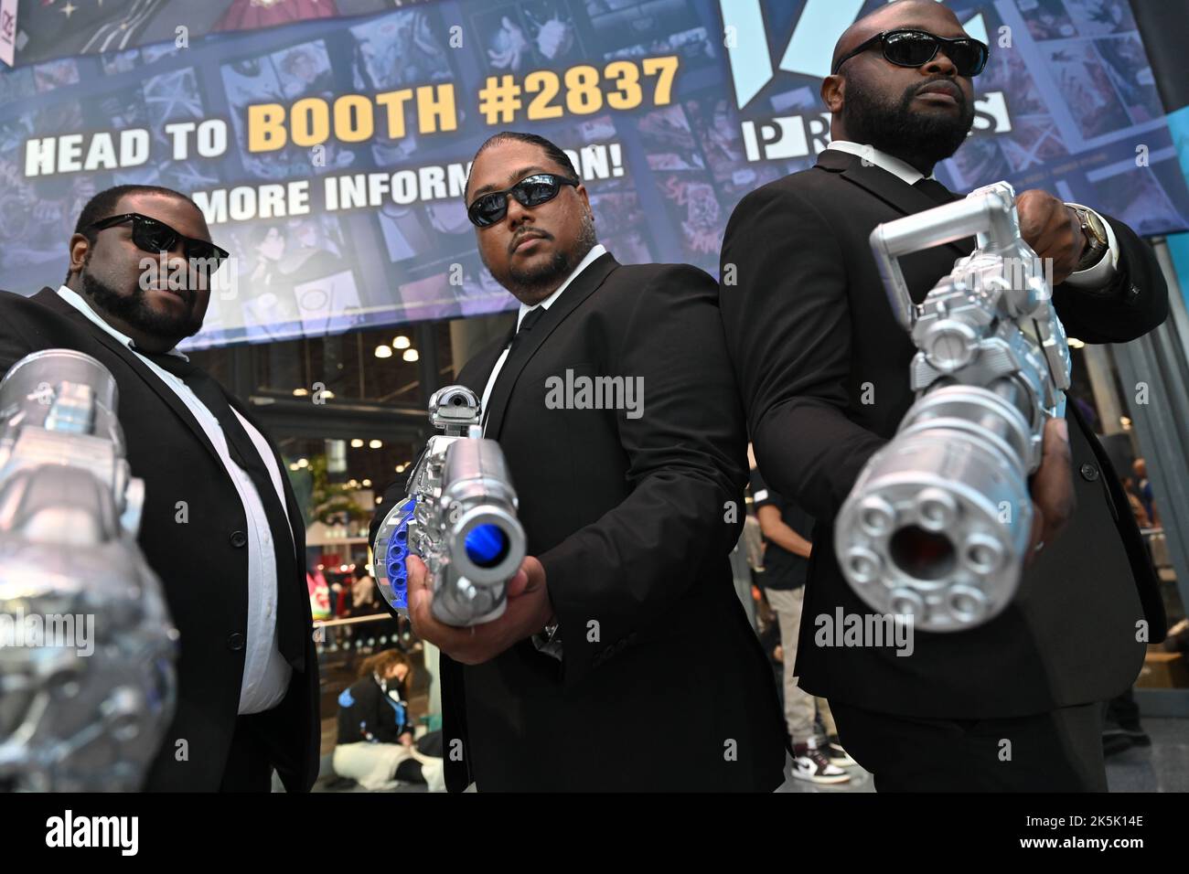 Cosplayers dress as Men In Black attend New York Comic Con 2022 on ...