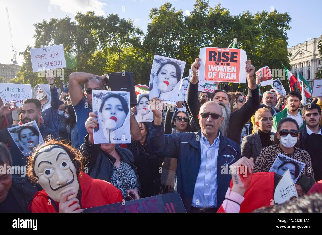 Protesters hold portraits of Mahsa Amini during the demonstration ...