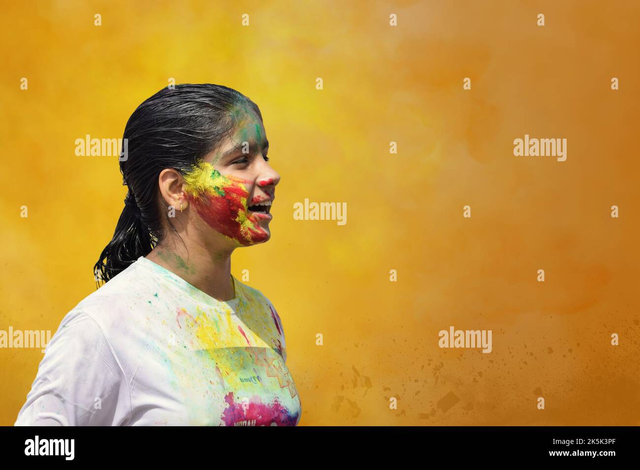 Young teenage girl with colours on face celebrating holi Stock Photo ...