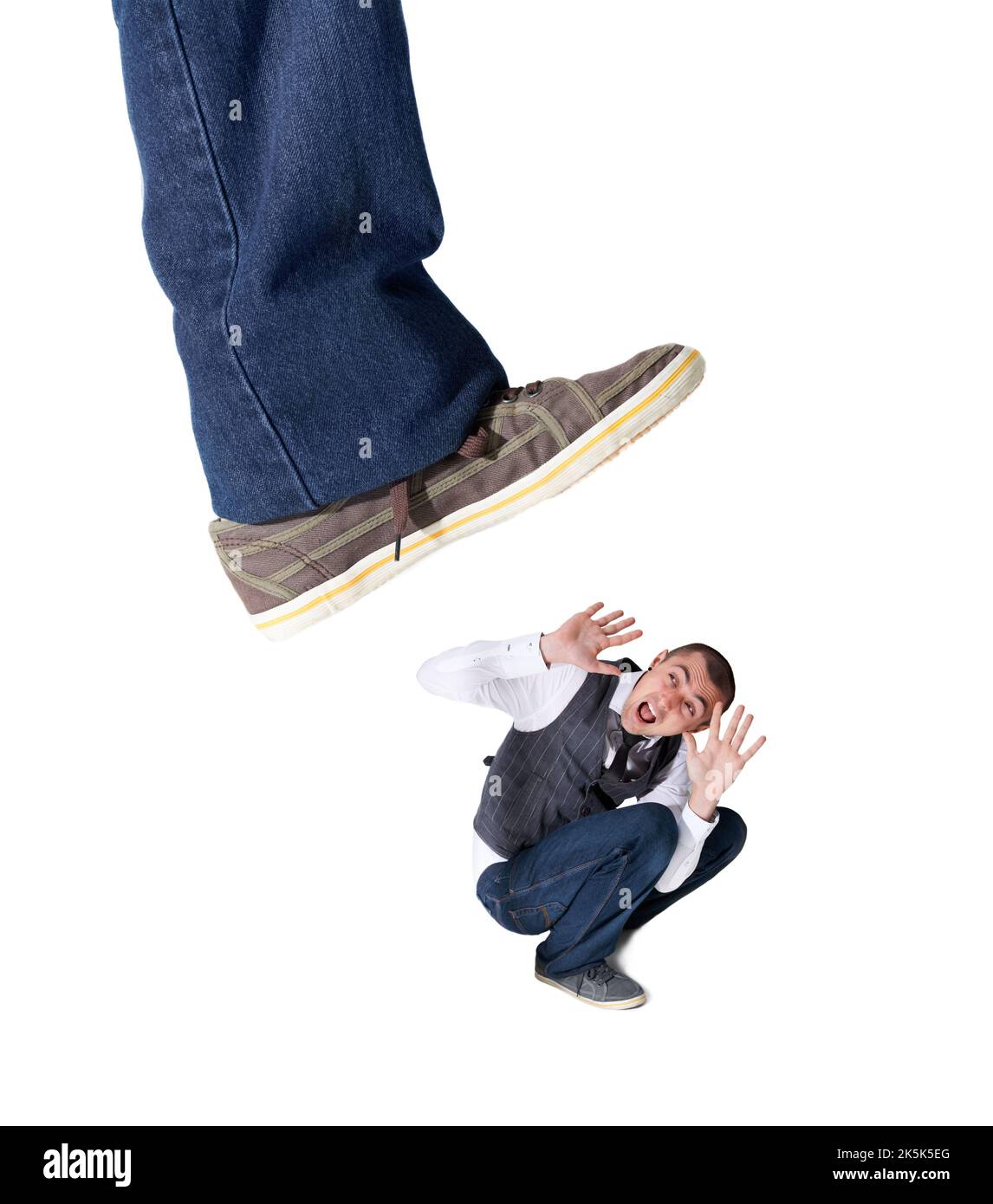 Feeling downtrodden. A fearful young man lying on the ground with a ...