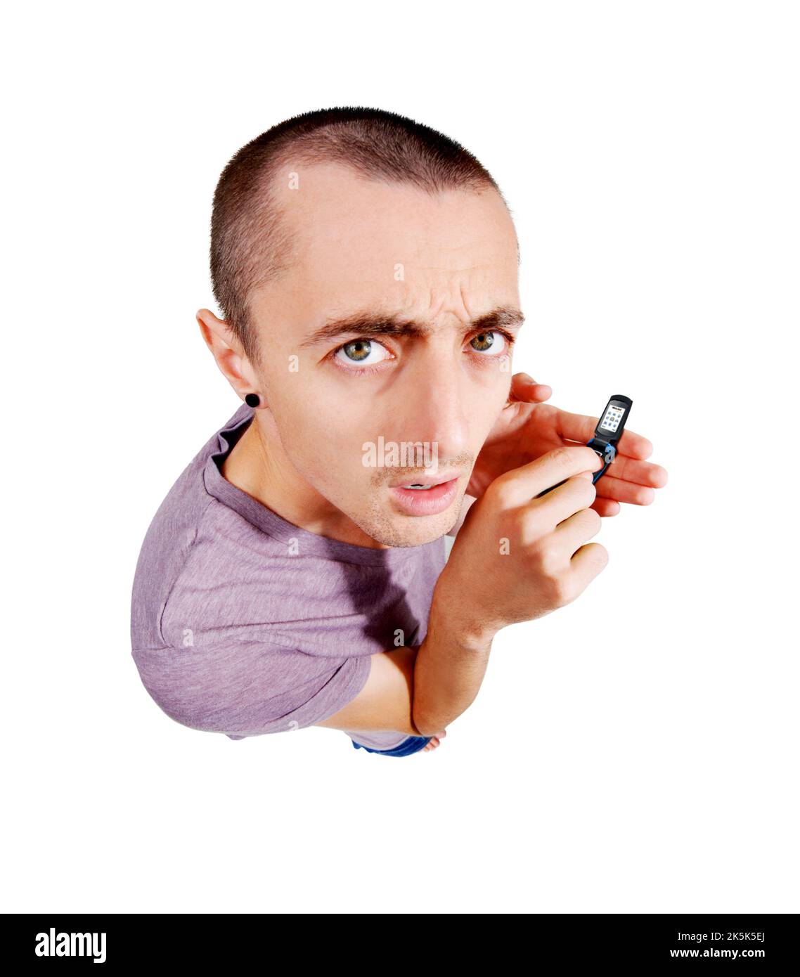 Struggling with new technology. A puzzled young man trying to dial on a ...