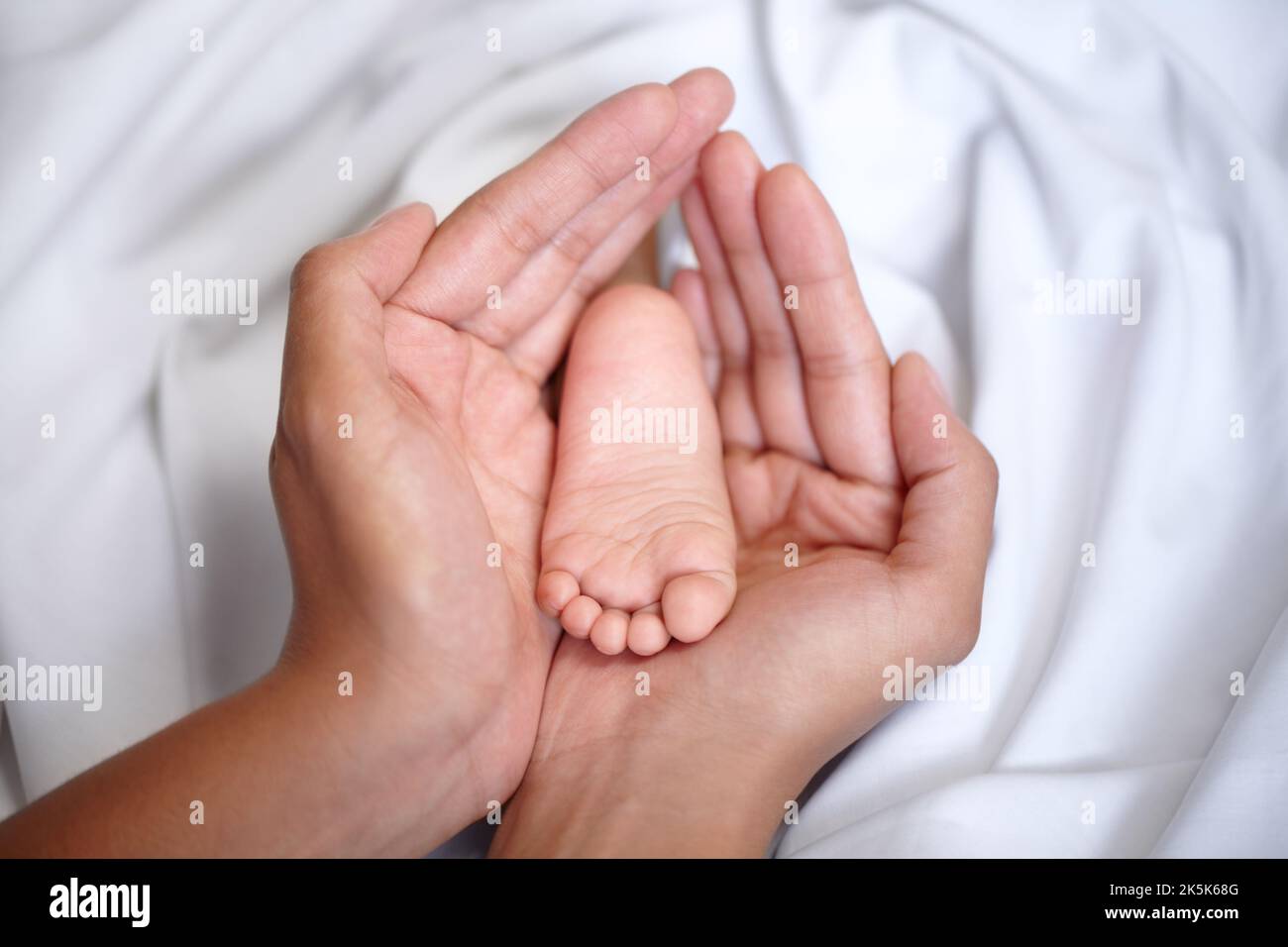 Taking in this precious moment. Closeup of a mothers hands holding her ...