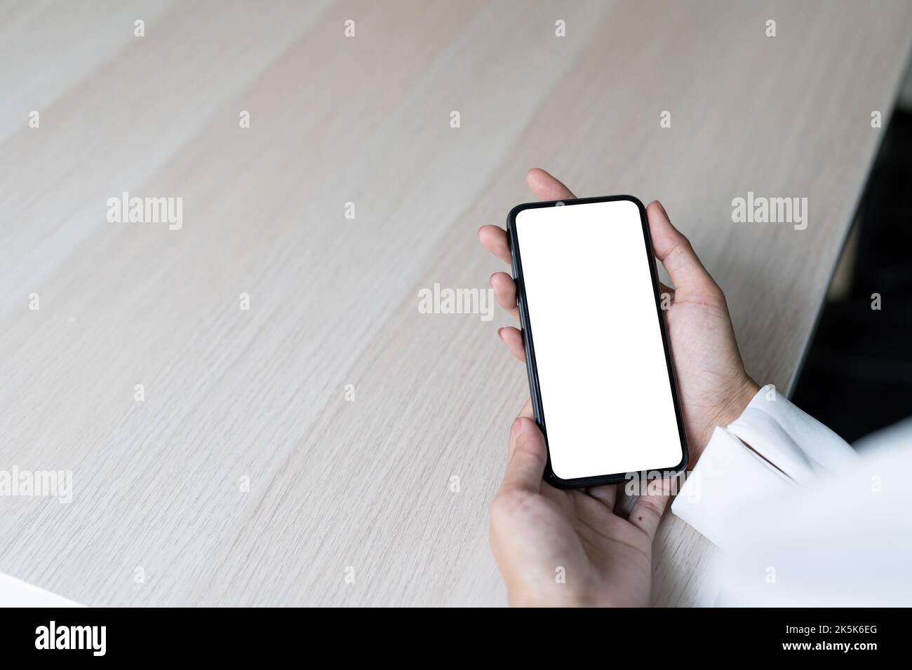 Cropped shot view of man hands holding smart phone with blank copy ...
