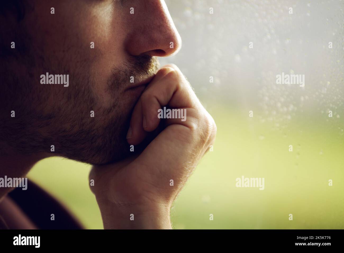 Hes deep in thought. Cropped image of a young mans face with his hand ...