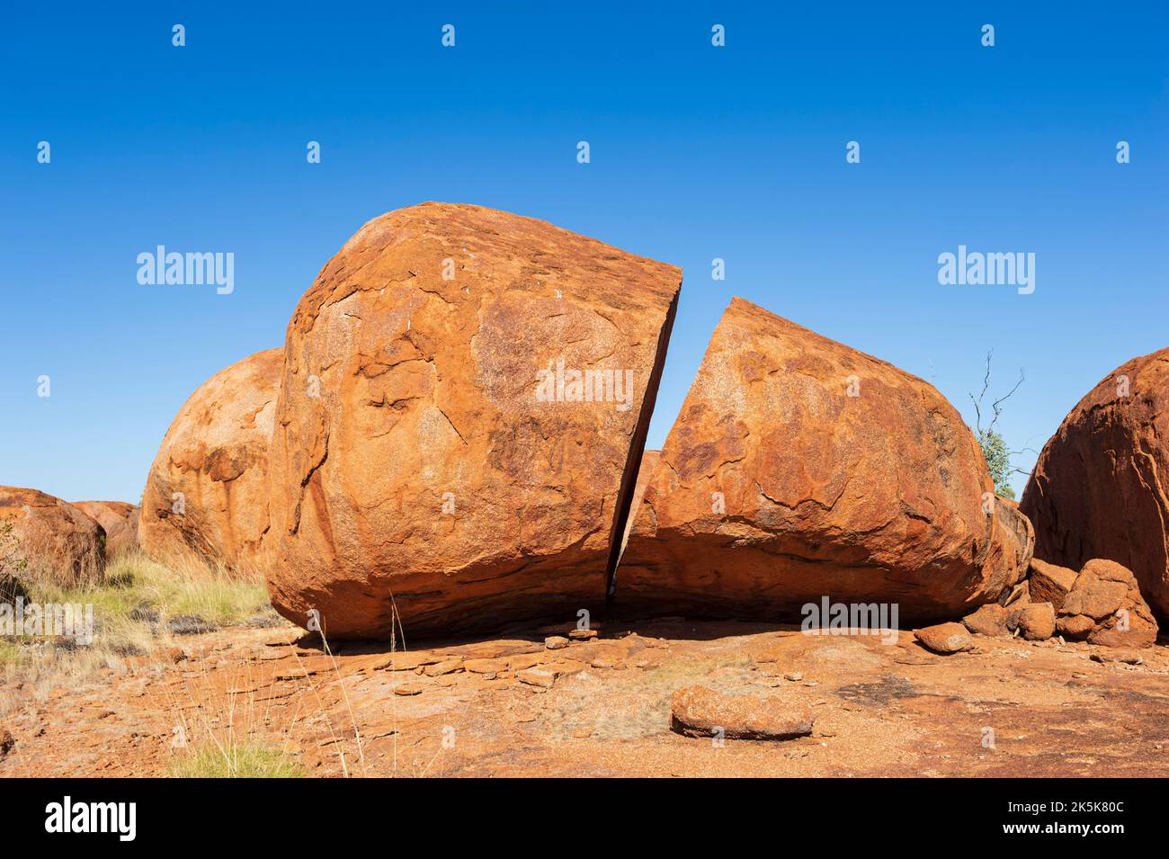 Split granite boulder at Devil's Marbles, a popular tourist destination ...
