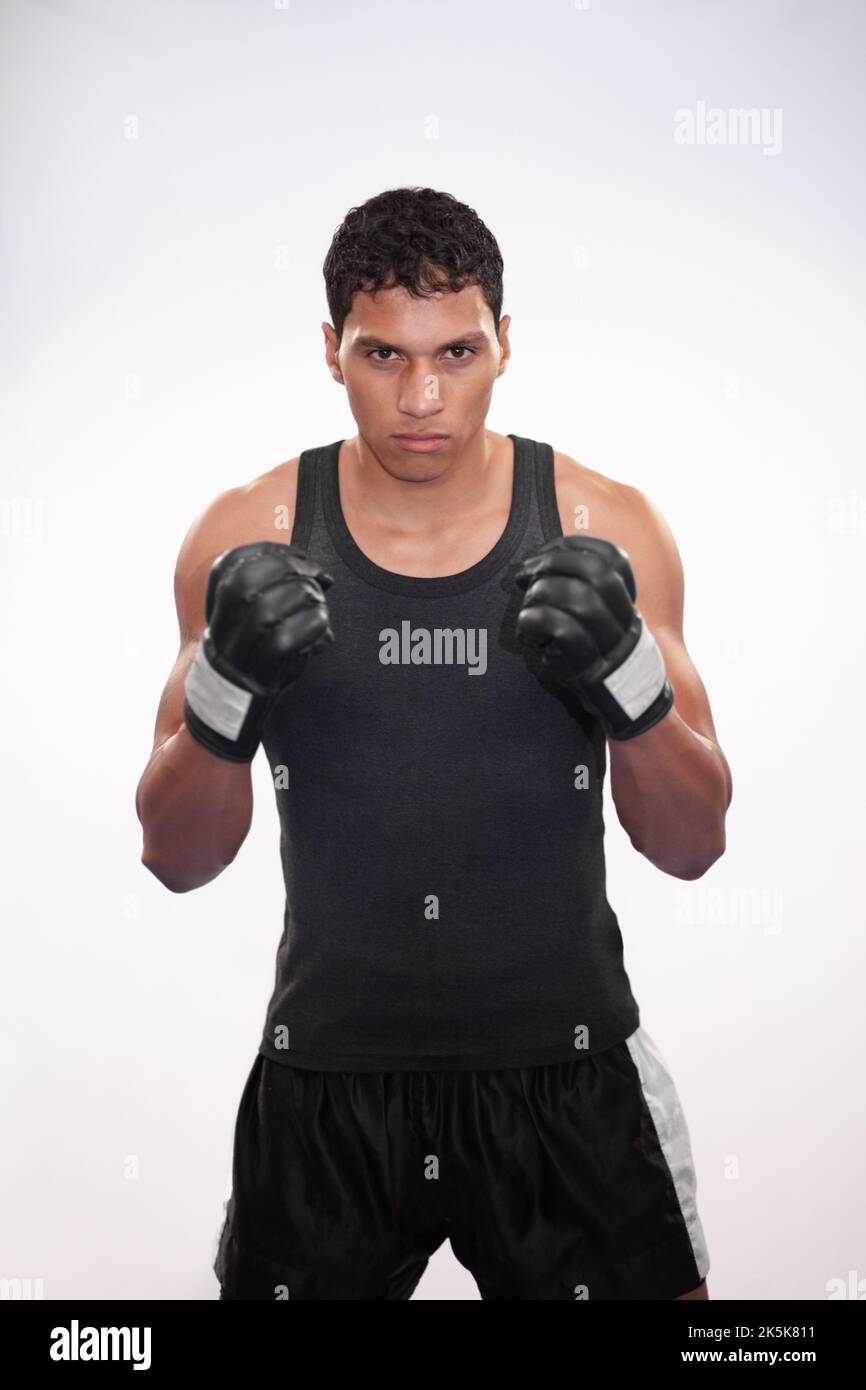 You can see the fight in his eyes. Portrait of a young boxer in front ...