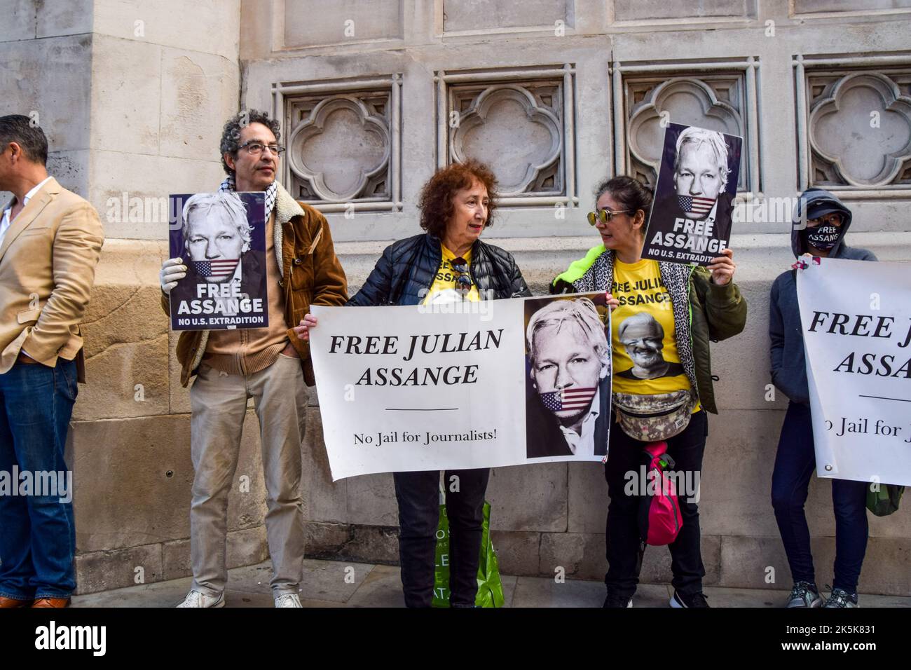 Julian Assange supporters hold "Free Assange" banners and placards ...