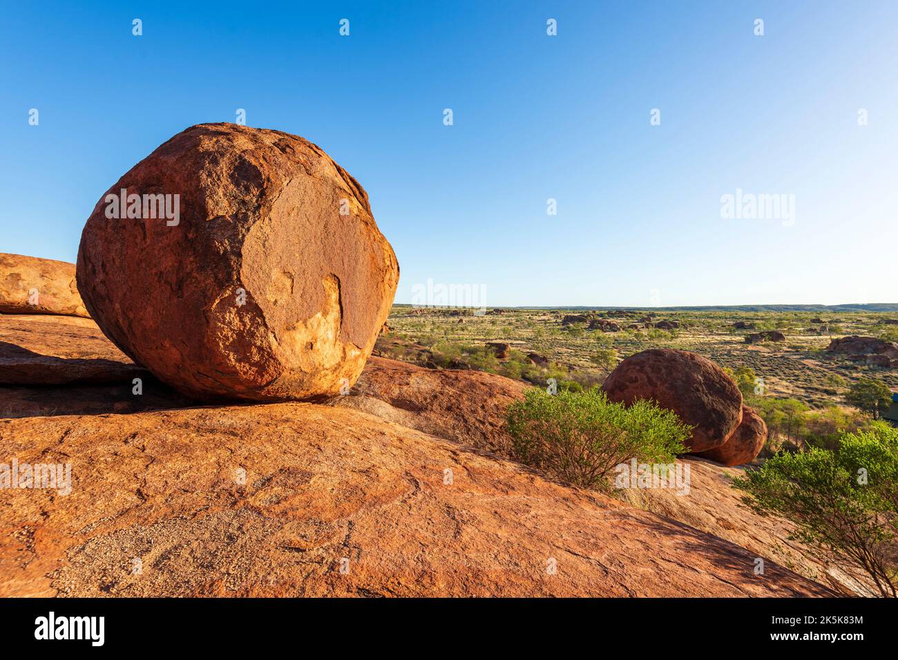 Balanced round eroded granite boulder at Devil's Marbles, a popular ...
