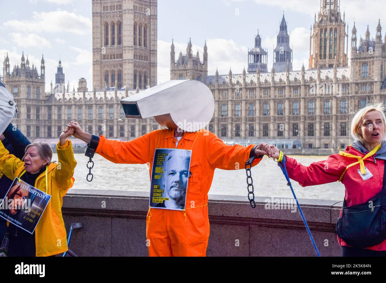 A Julian Assange supporter wears a giant whistle mask during the ...