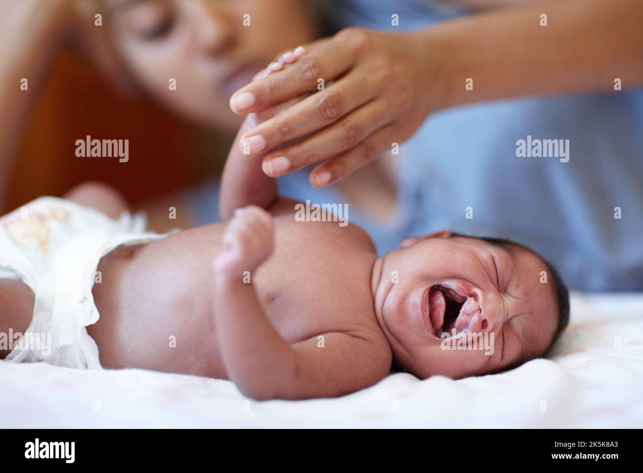 The cries of a baby. a baby girl with a cleft palate crying while her ...