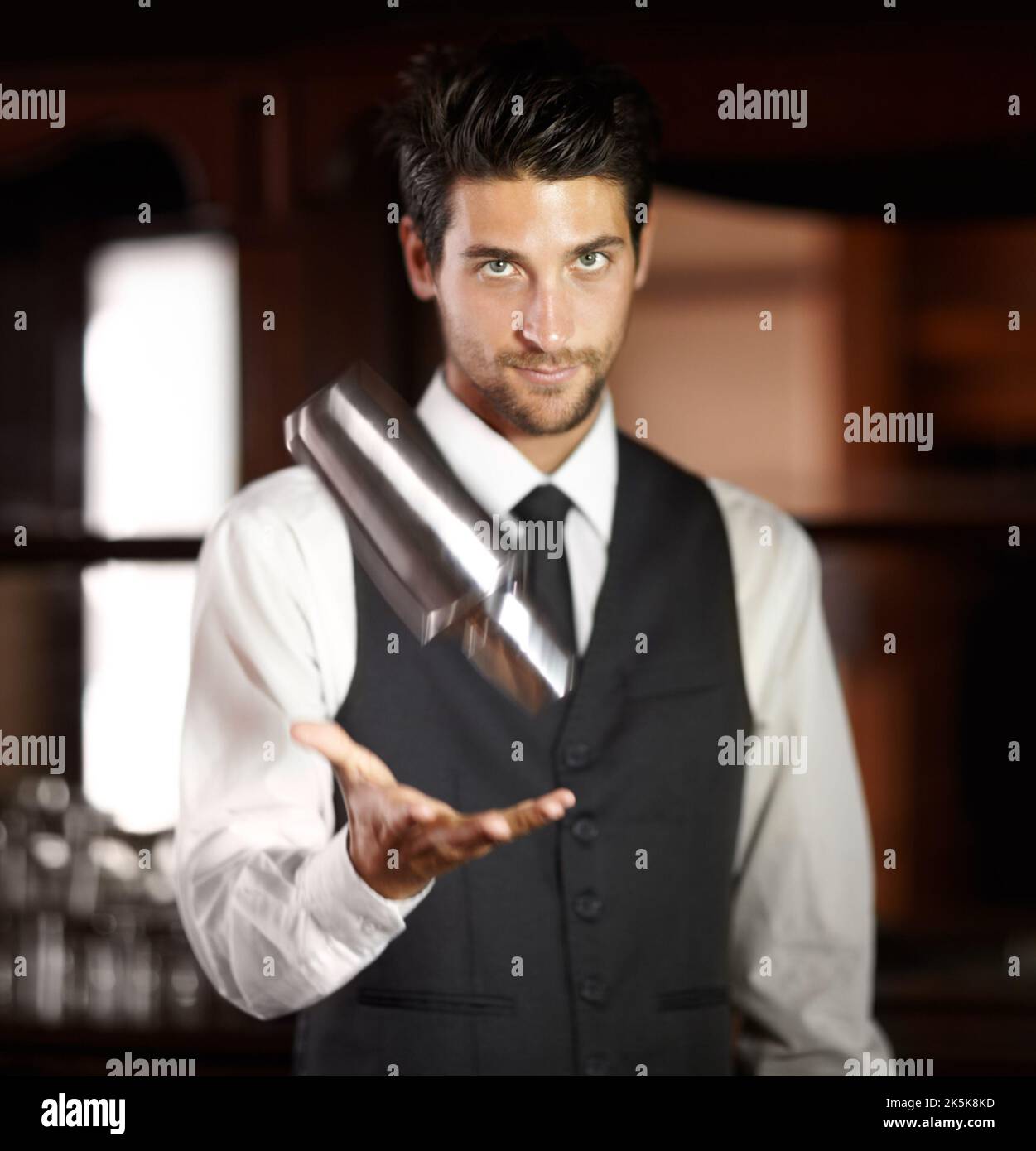 Hes a master cocktail mixer. Portrait of a handsome young bartender ...