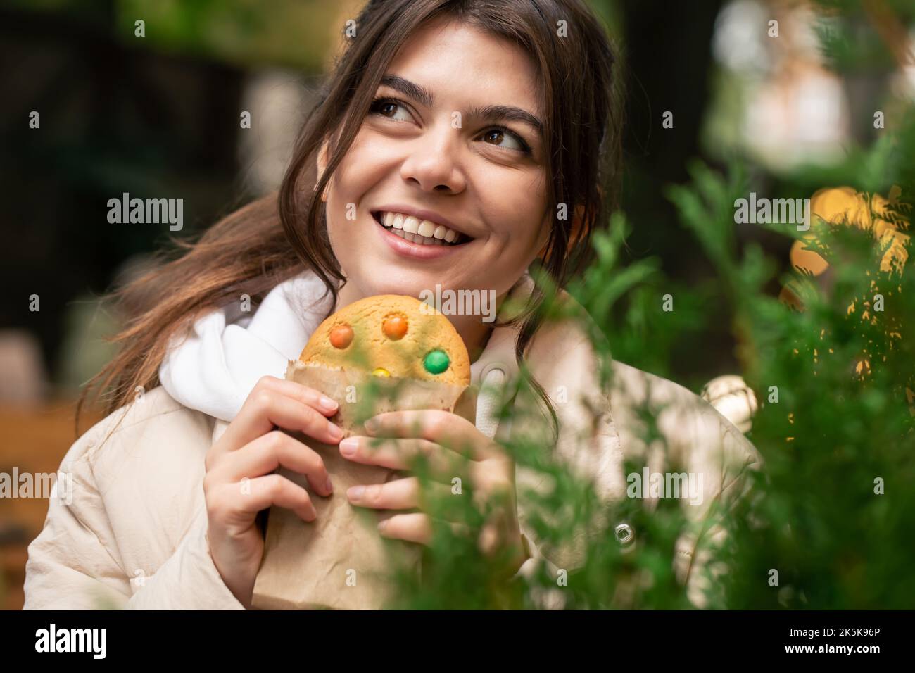 Attractive young woman with a beautiful gingerbread on a walk Stock ...