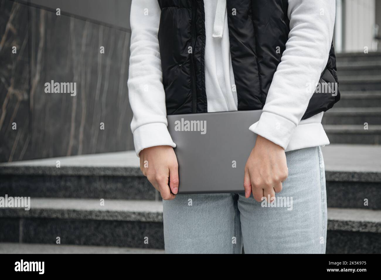 Close-up, a woman is using a tablet outside Stock Photo - Alamy