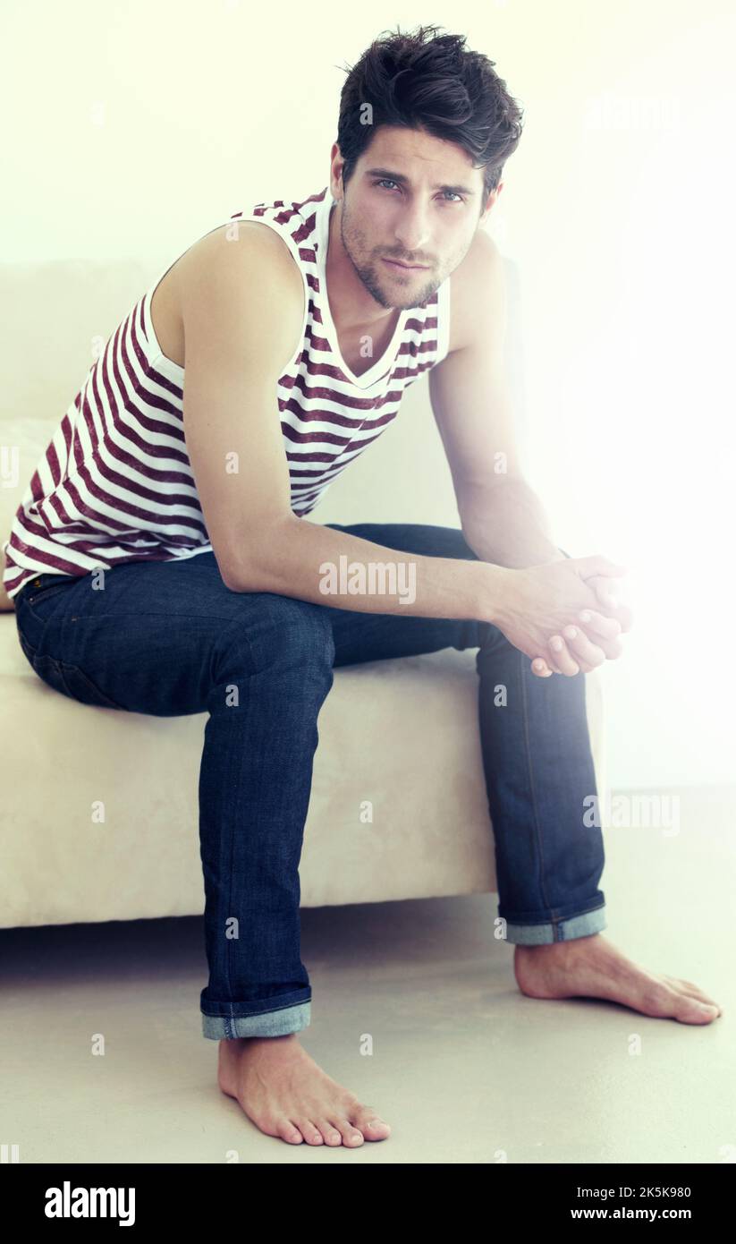 Casual about life. Portrait of a serious attractive male sitting on a ...