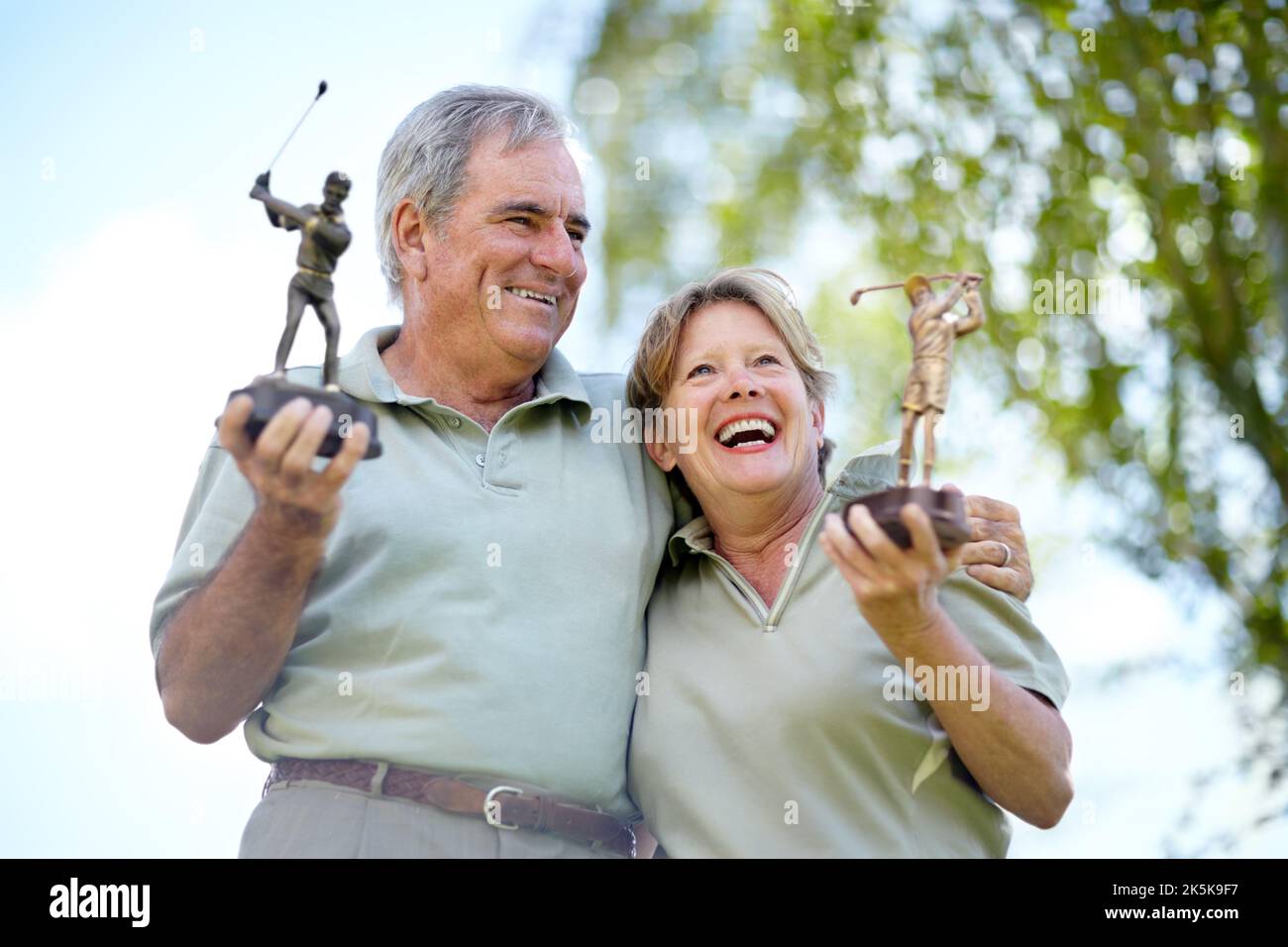 Champions of golf. Low angle view of a mature couple laughing and ...