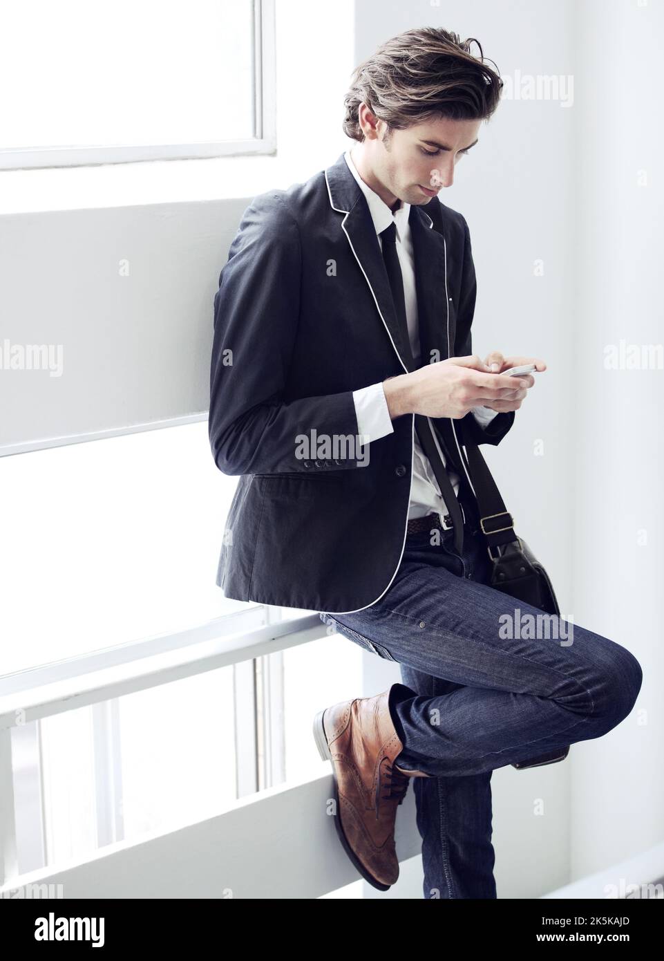 Serious about his text. A young man reading the reply he received Stock ...