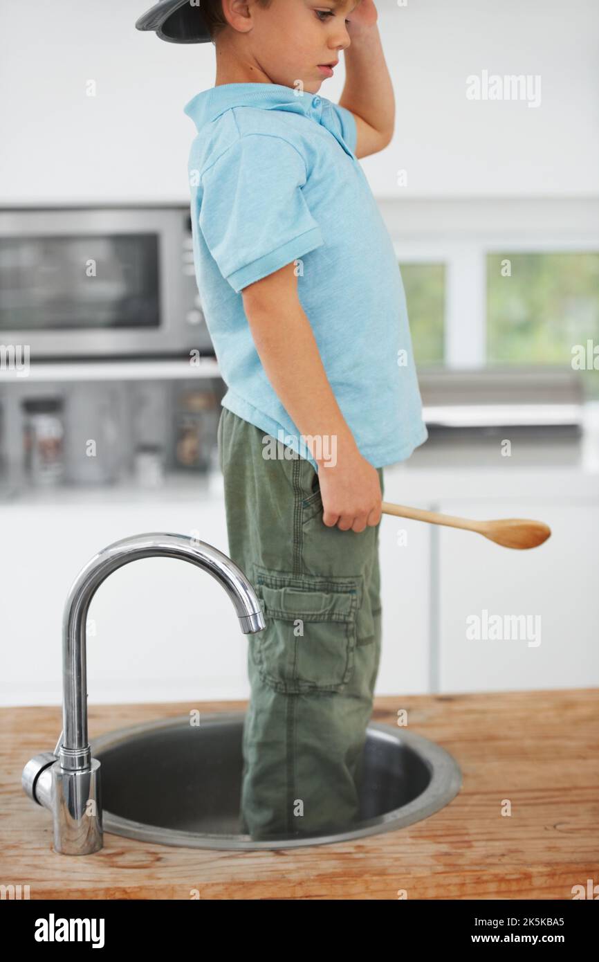 This sink is my castle. Cropped image of a cute young boy standing in ...