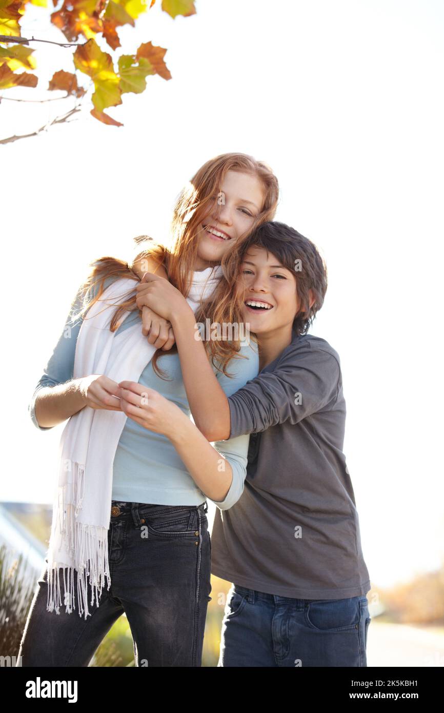 Hes got her back. Portrait of a young boy with his arms around his ...
