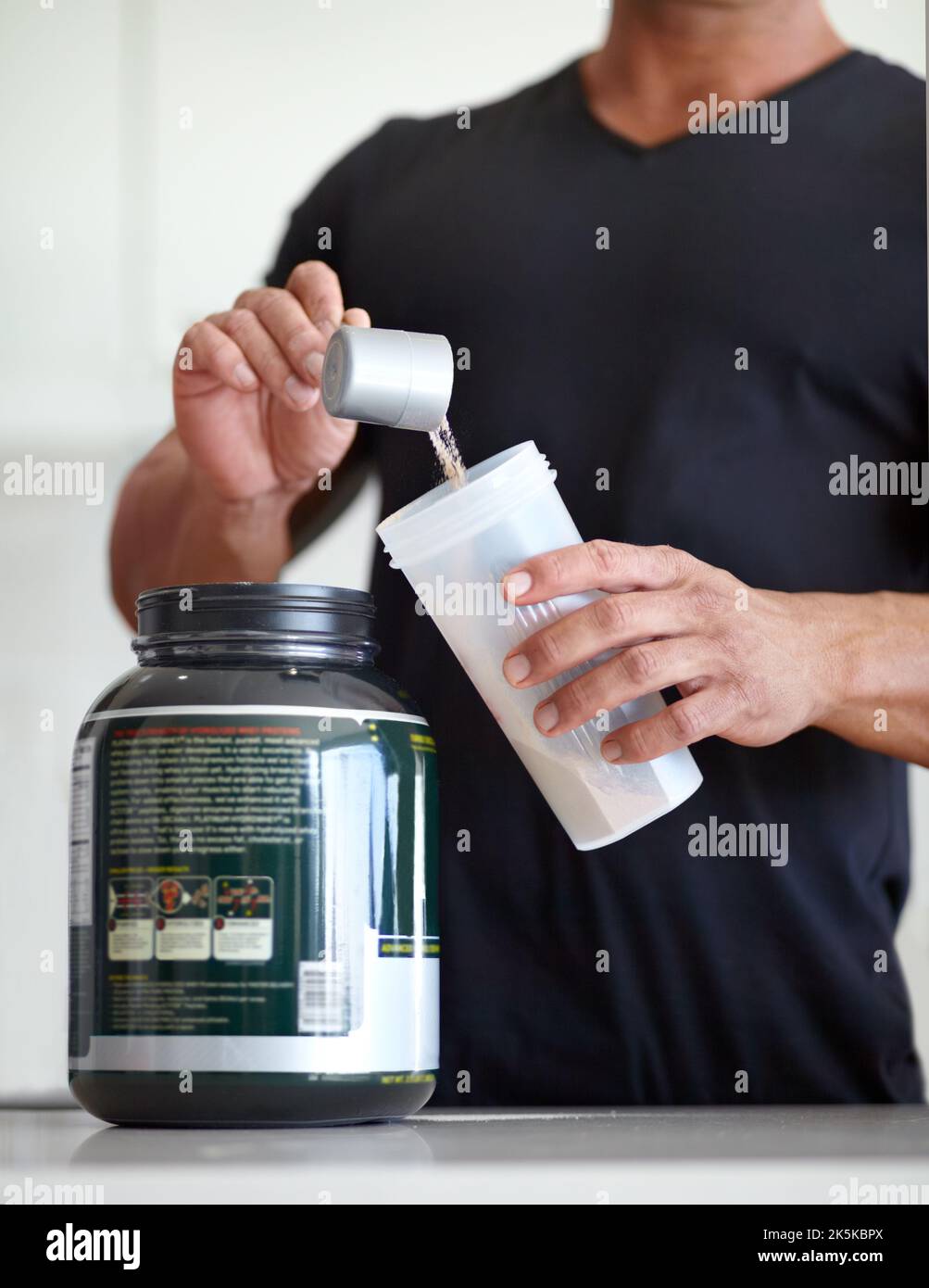 Adding some extra protein to his diet. Cropped image of a bodybuilder ...