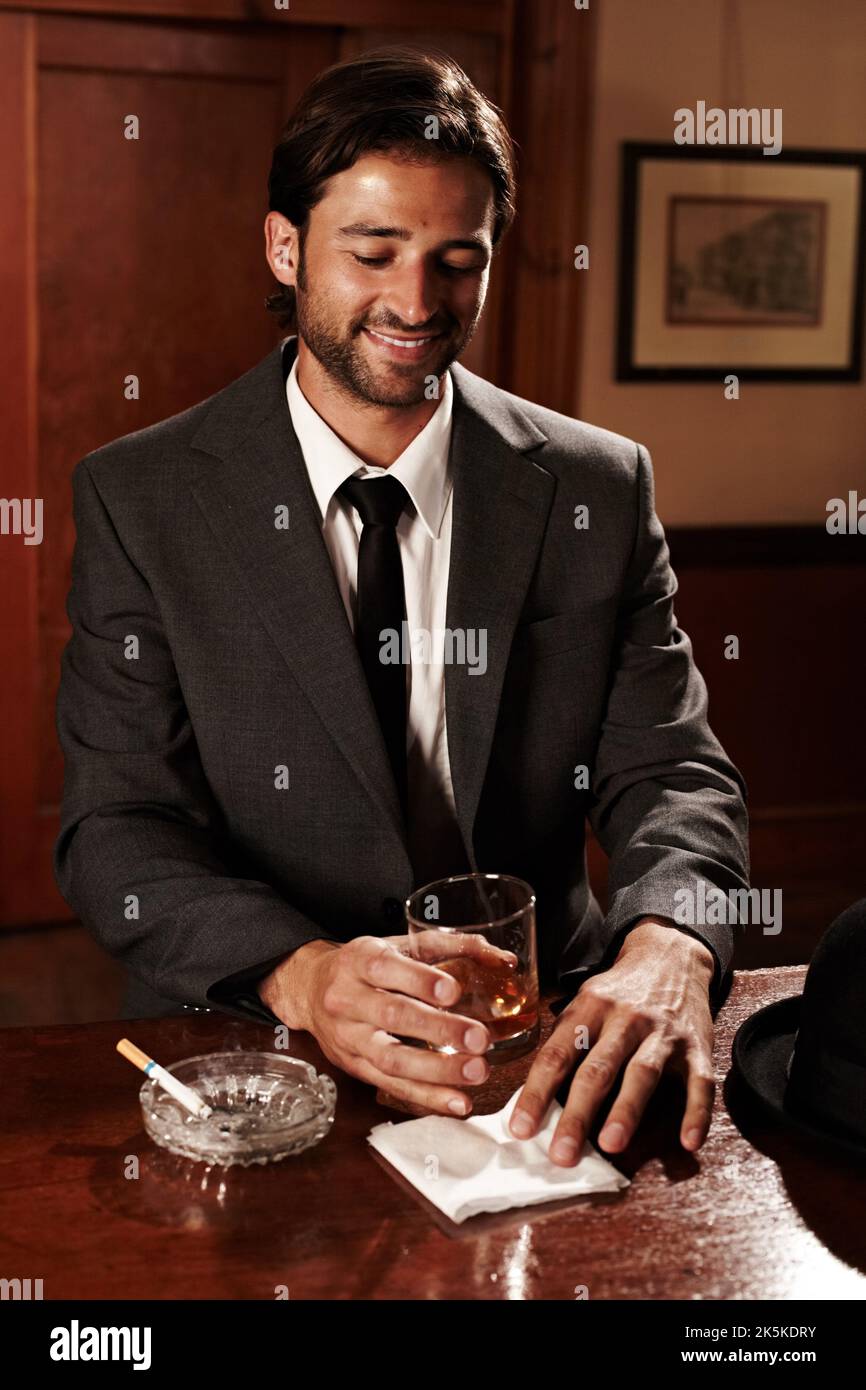 Just taking it easy. Portrait of a well-dressed young man sitting at a ...