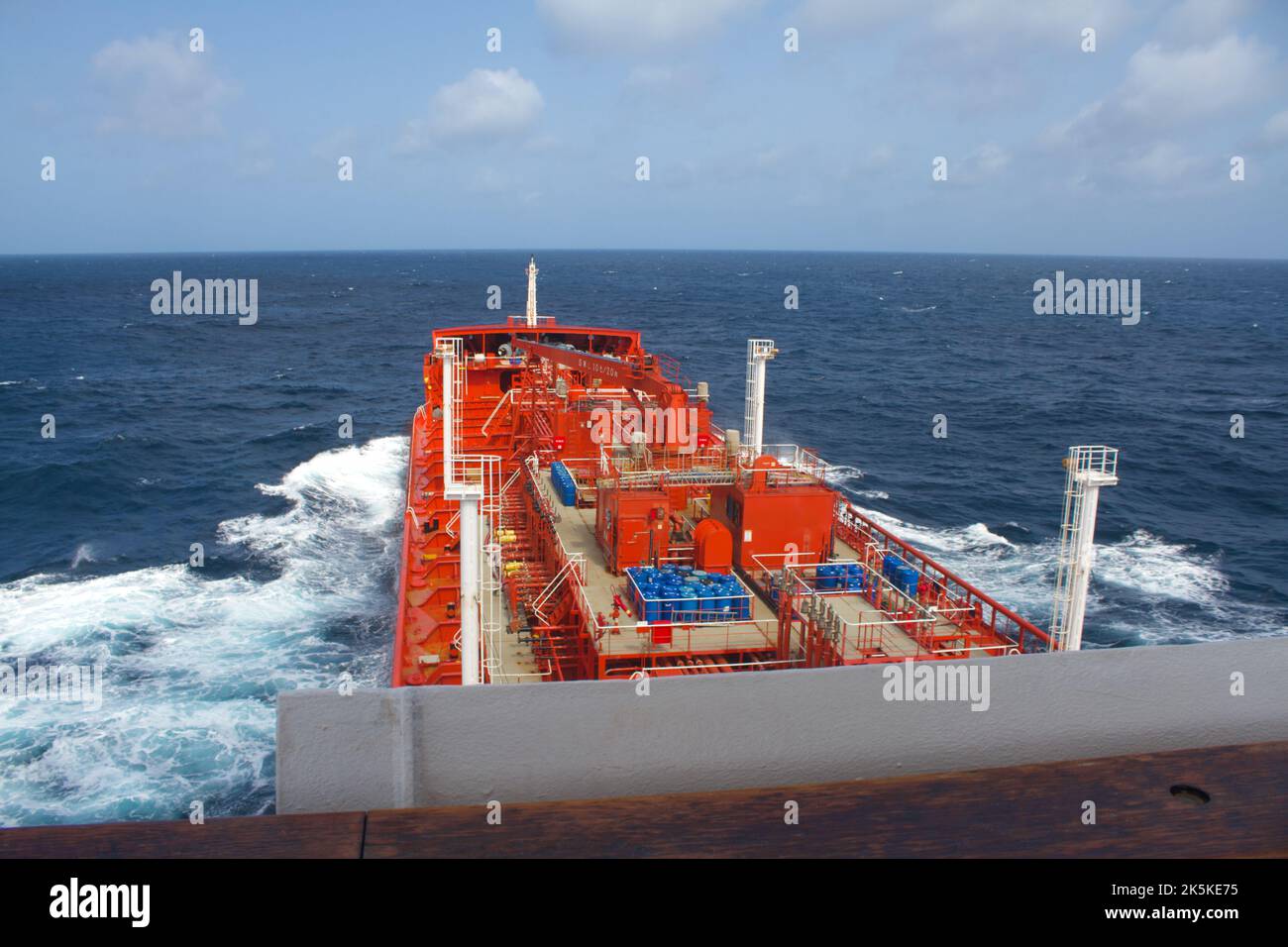 A merchant ship carrying product is underway at sea, view from the mast ...
