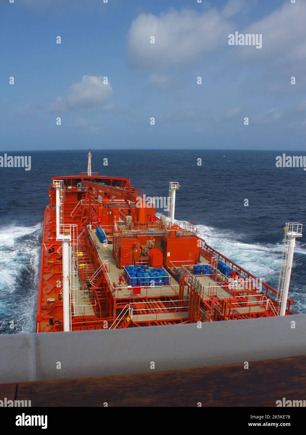 A merchant ship carrying product is underway at sea, view from the mast ...
