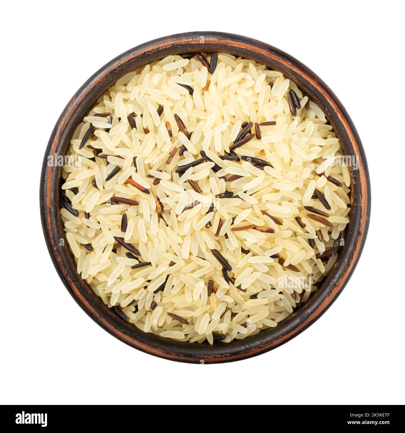 Wild rice in clay bowl, isolated on a white background. File contains ...