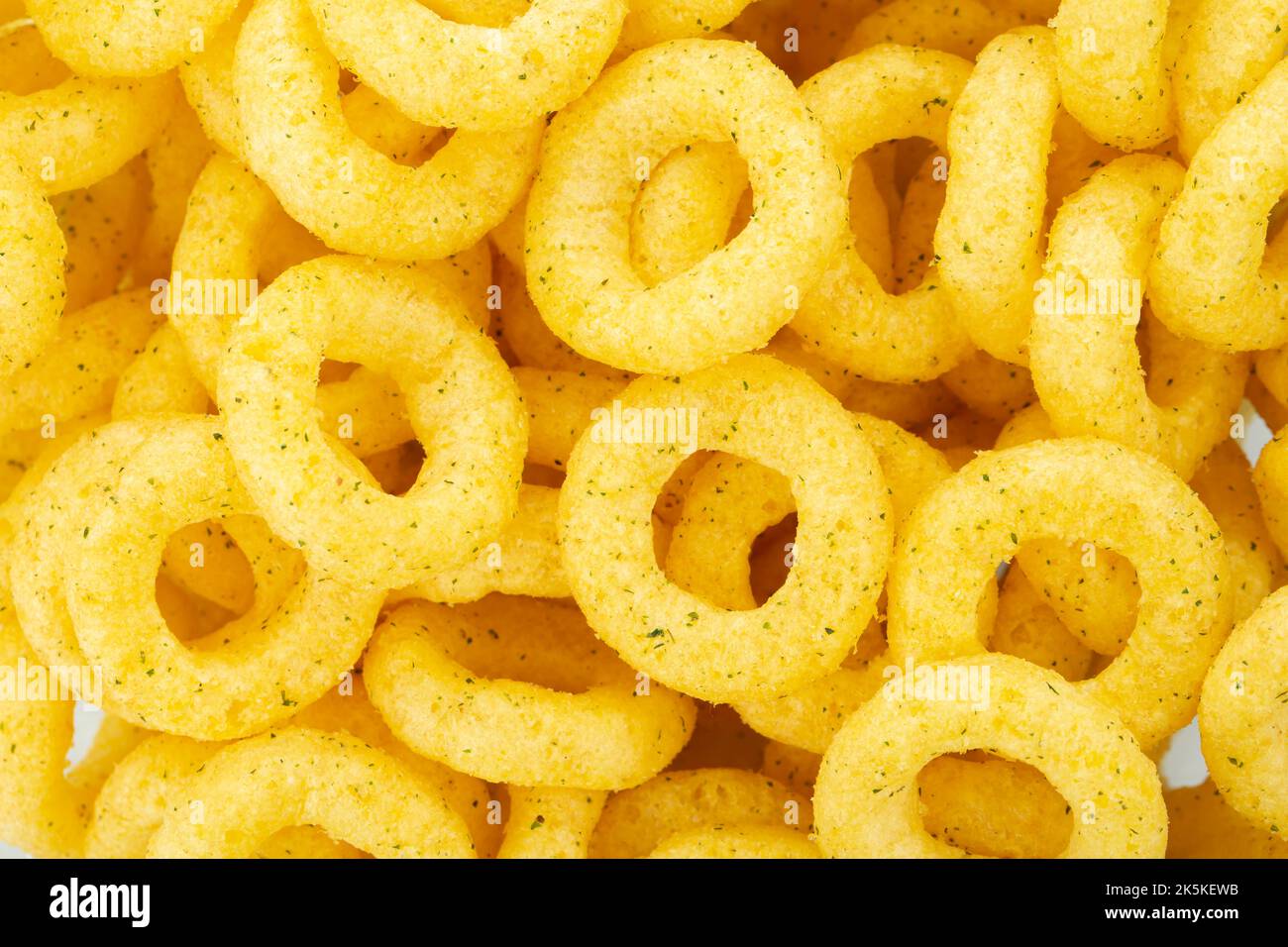Beer snacks. Background of corn rings of sticks with cheese and green ...