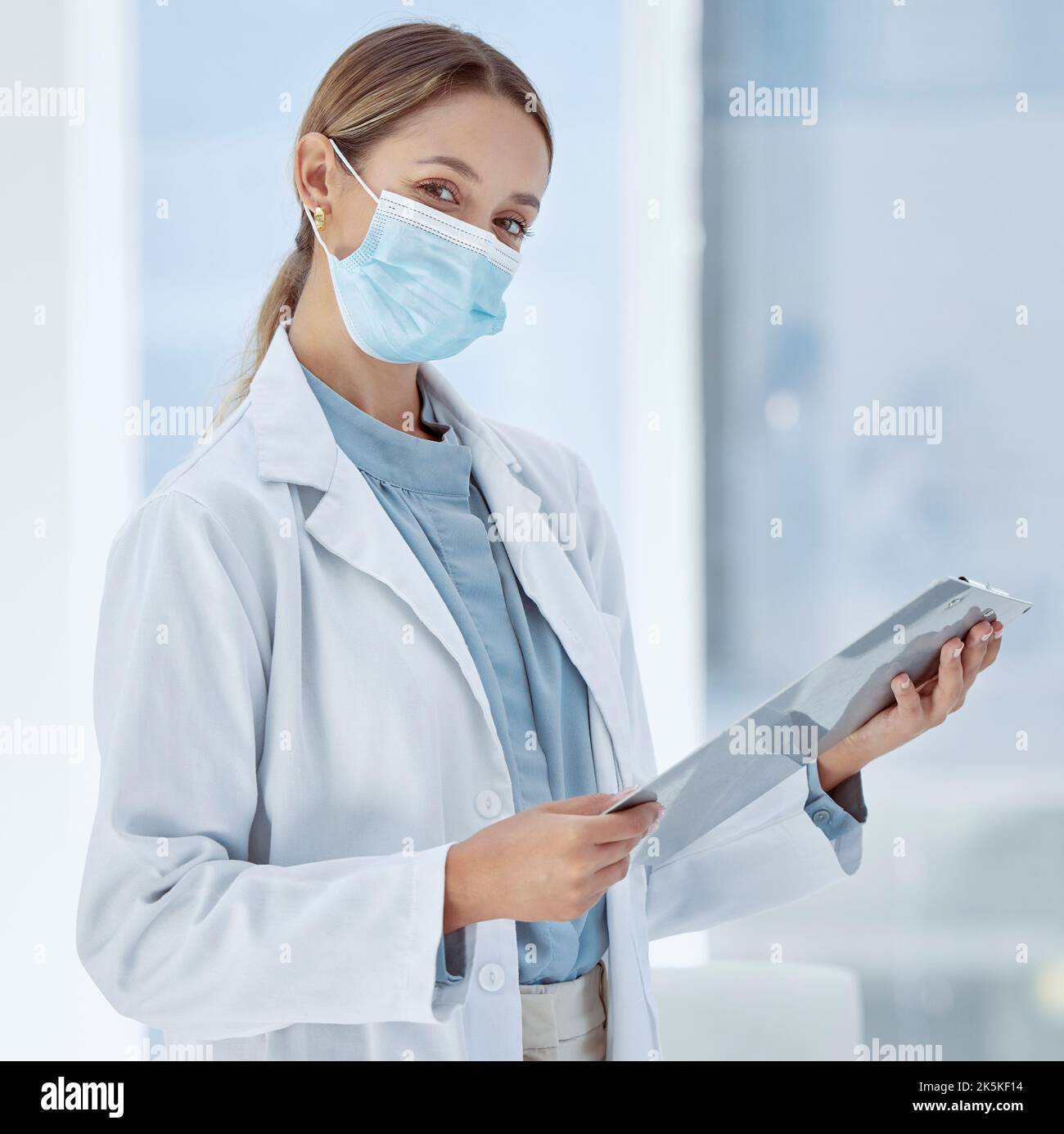 Doctor with covid face mask and a checklist for compliance, risk ...