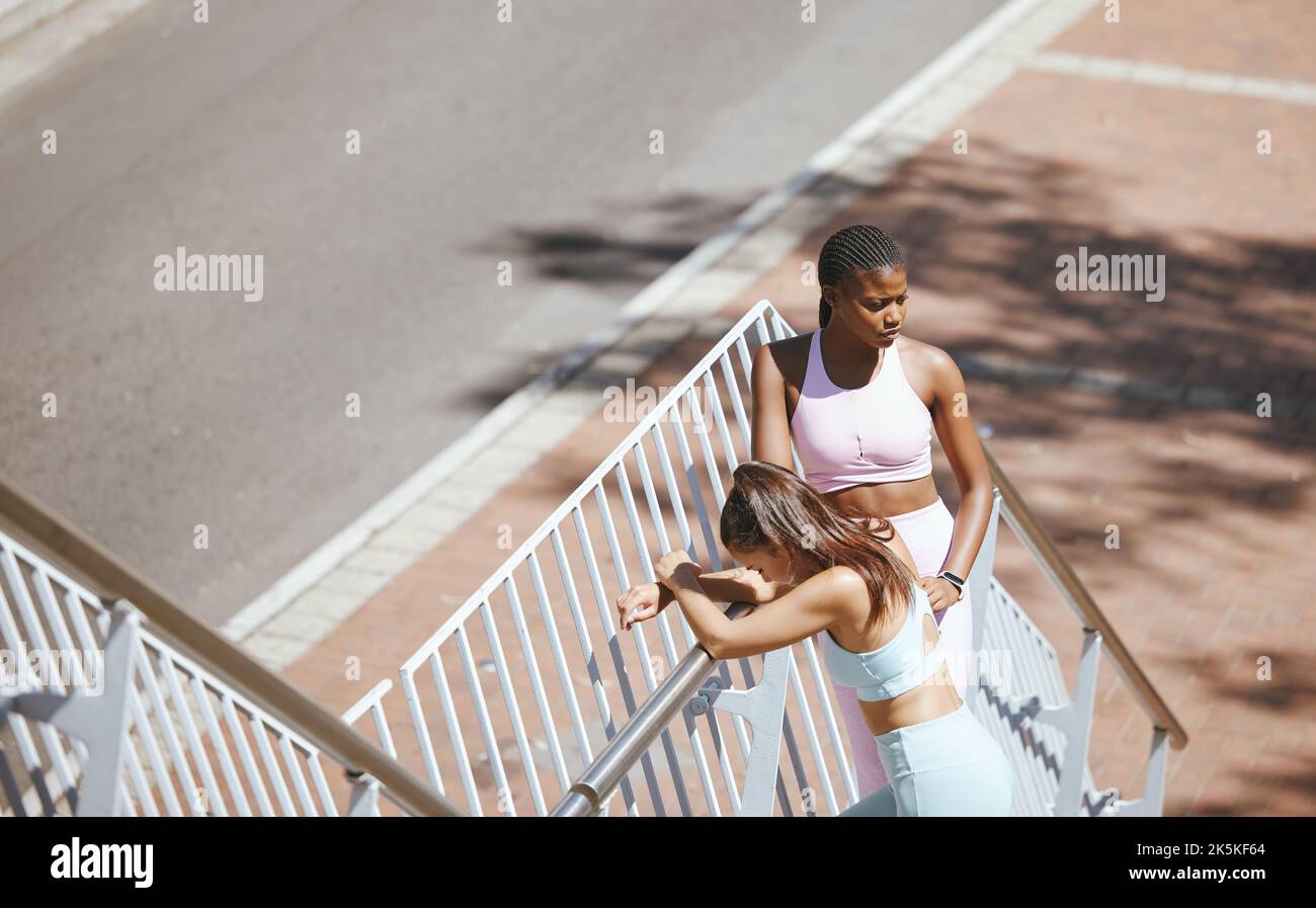 Women, tired and relax in stairs workout, training and exercise in New ...