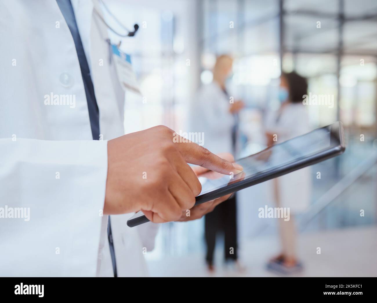 Man hands of hospital doctor with tablet to search through digital ...
