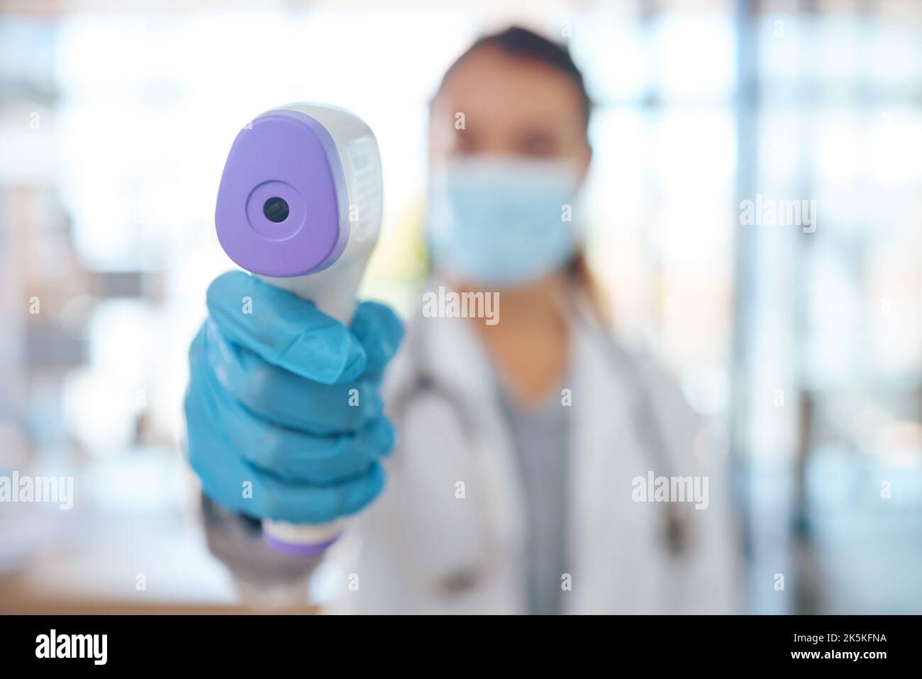 Hand, woman doctor and covid test thermometer laser gun for medical ...