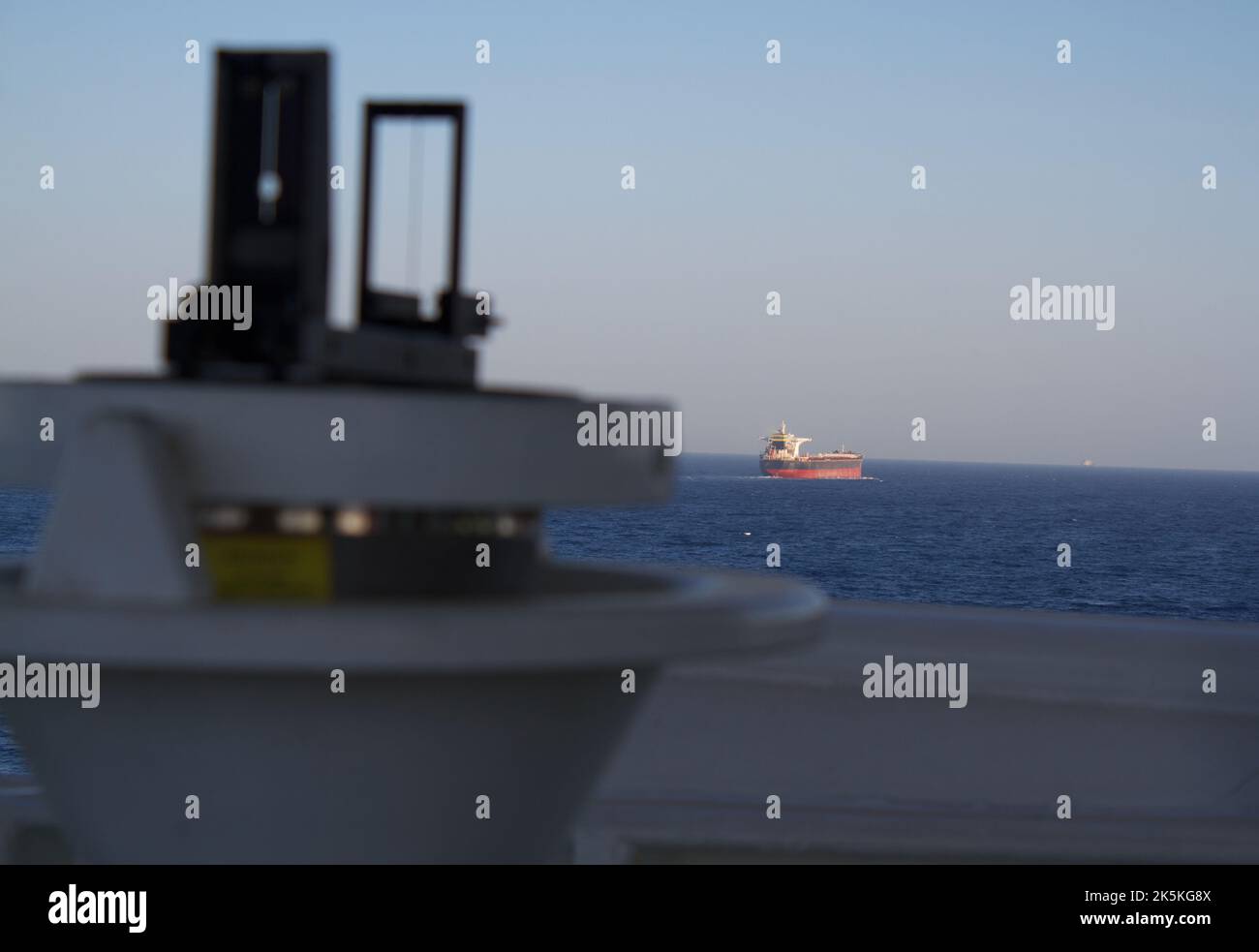 View of a merchant ship from the bridge wings of another ship at sea ...
