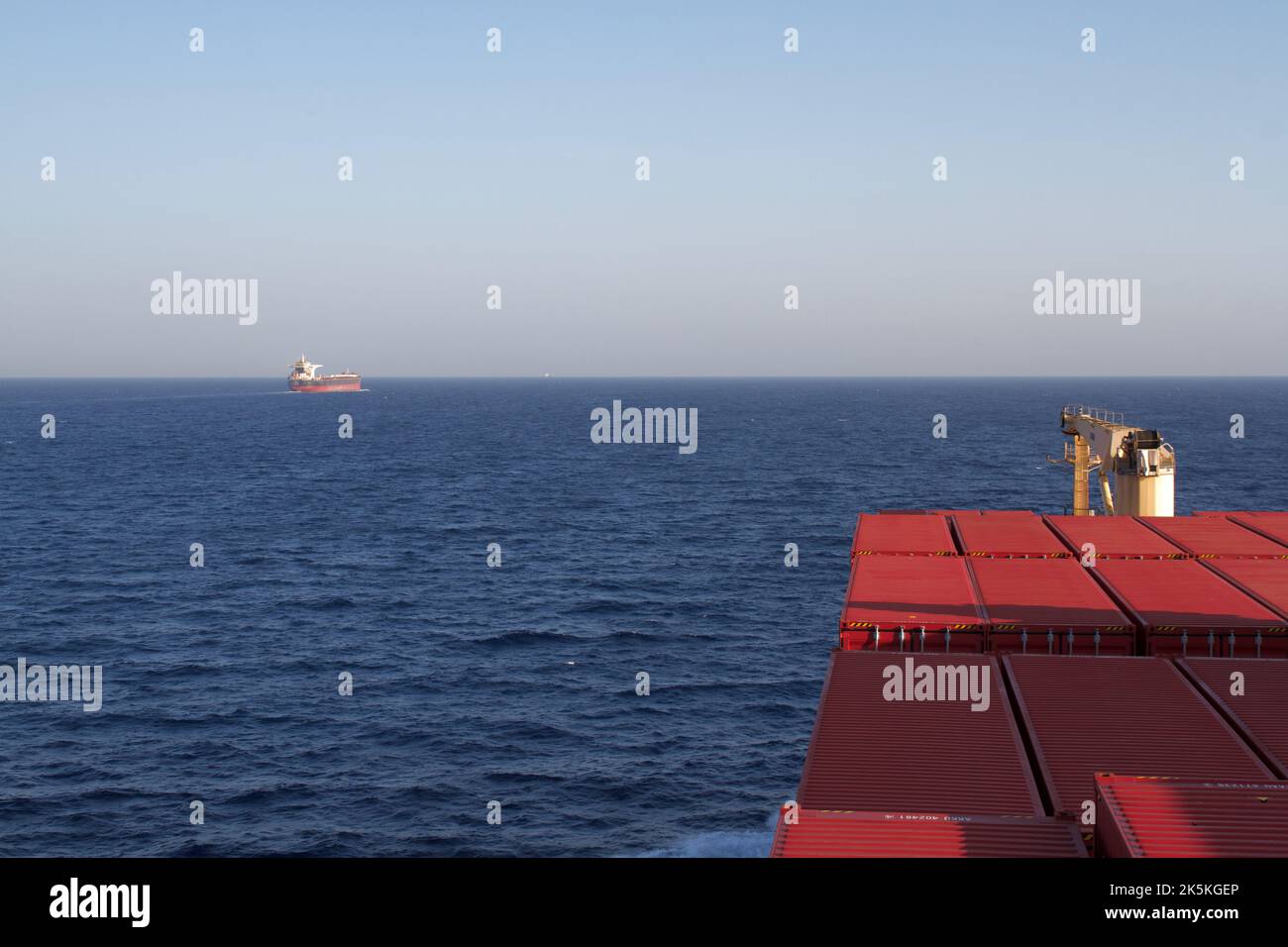Merchant ship carrying container is underway at sea in calm weather ...