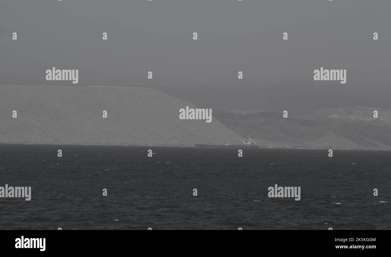 Merchant ship carrying bulk cargo is underway at sea in calm weather ...