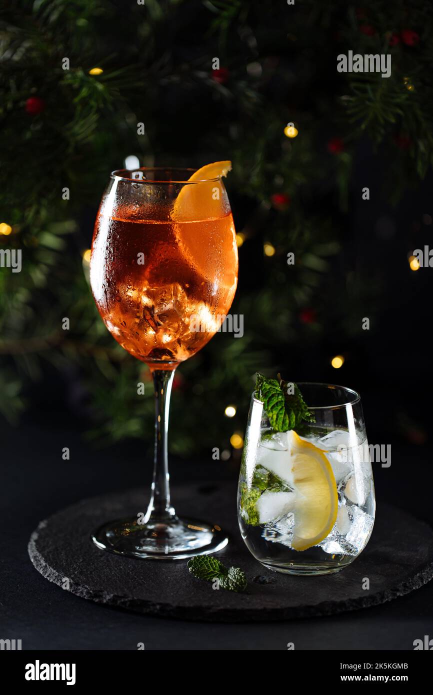 Cocktail called orange spritz and gin tonic or Moscow mule in dark ...