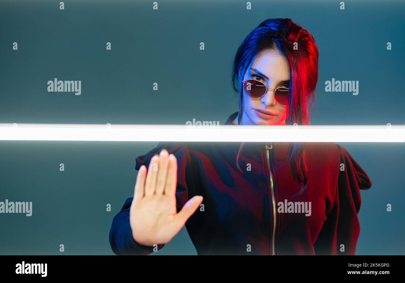 Stop discrimination. Neon light portrait. Feminist empowerment. Strict ...