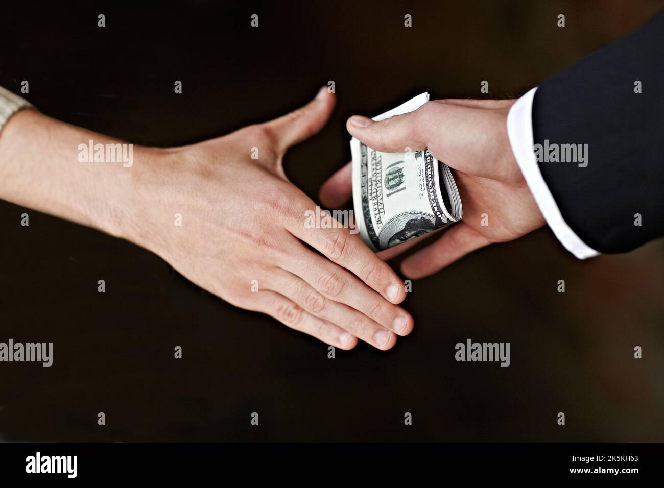 Ensuring the outcome. hands receiving an illegal payoff Stock Photo - Alamy