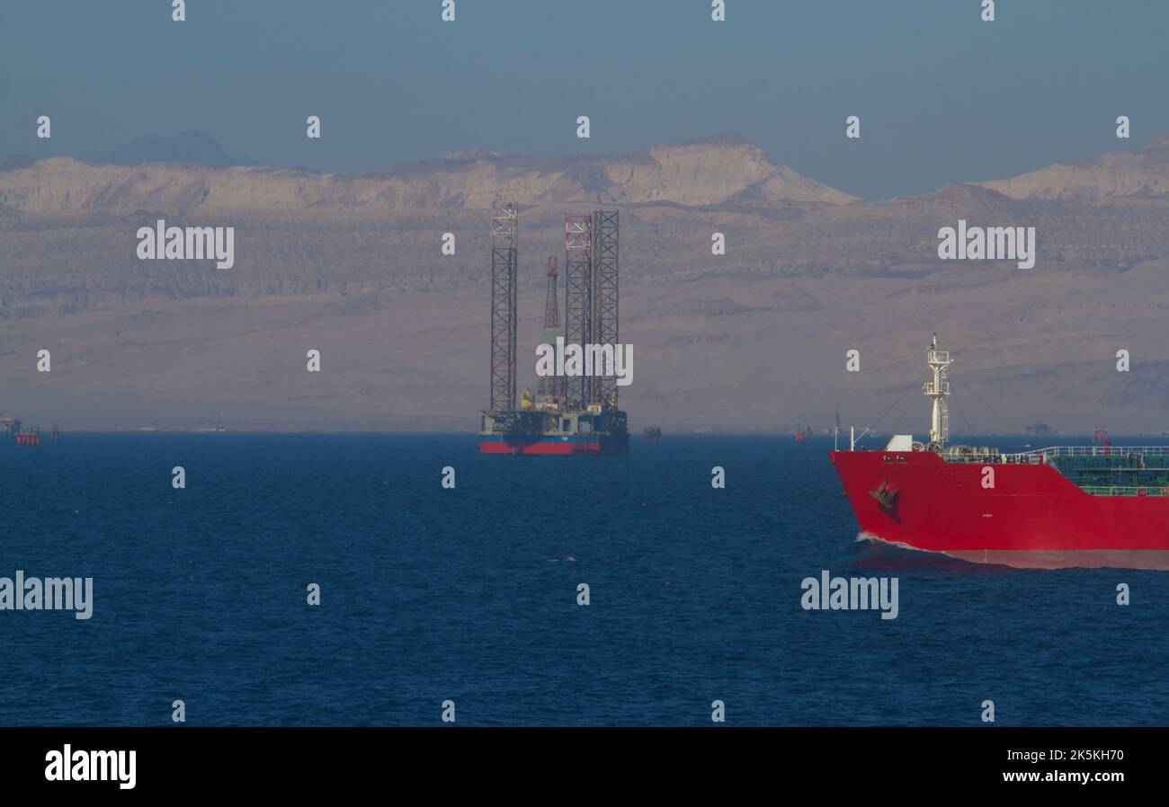 Oil drilling platform in red sea with Sinai mountains in the background ...