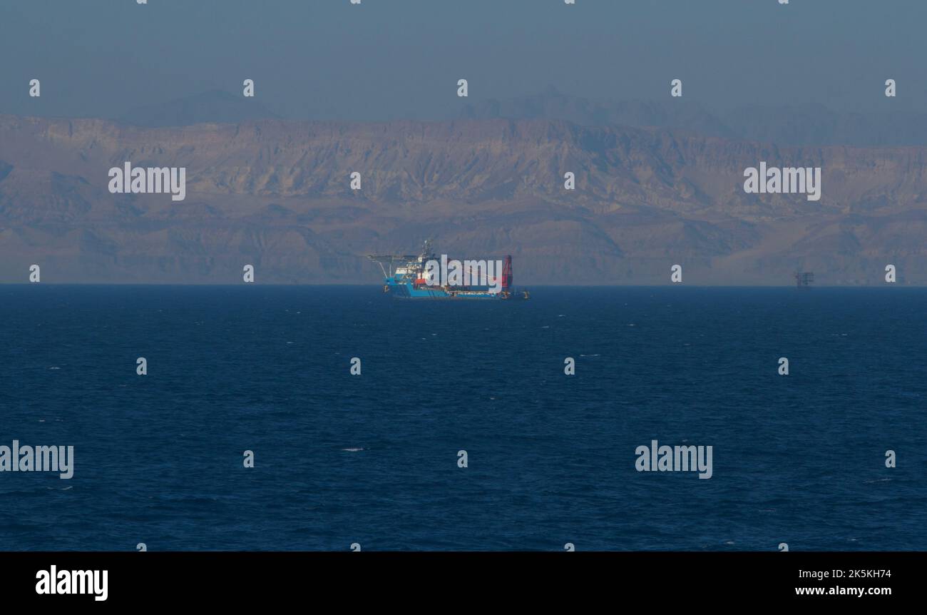 Oil drilling platform ship in red sea with Sinai mountains in the ...