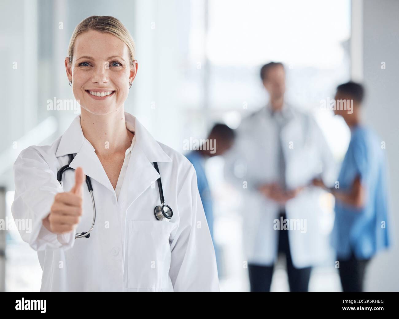 Thumbs up, smile and happy doctor, woman or success in a medical ...